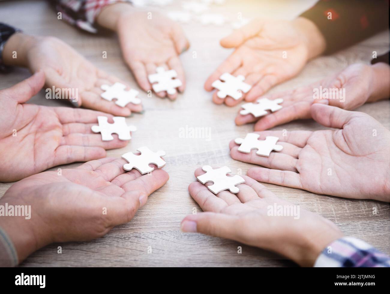 Hands of diverse people assembling jigsaw puzzle, Youth team put pieces ...