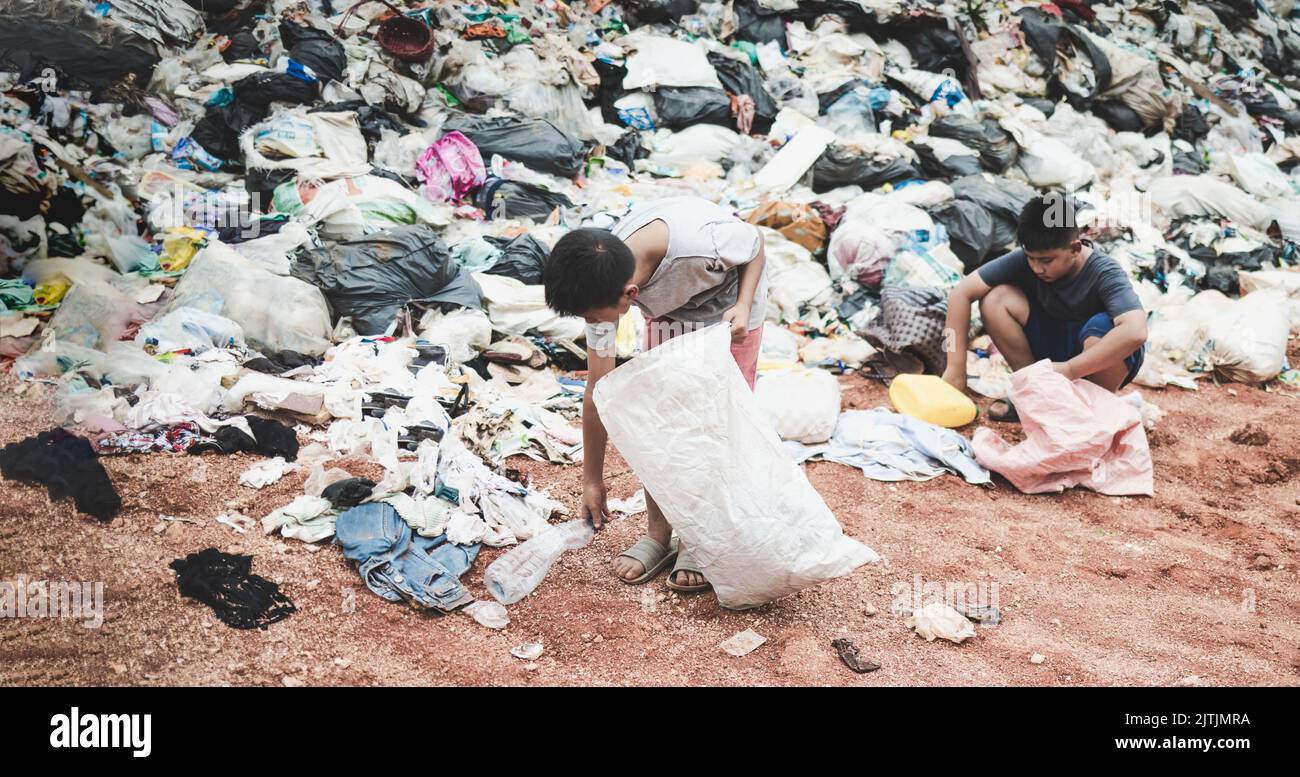 A young poor Indian boy collection waste plastic bottles in his sack to ...