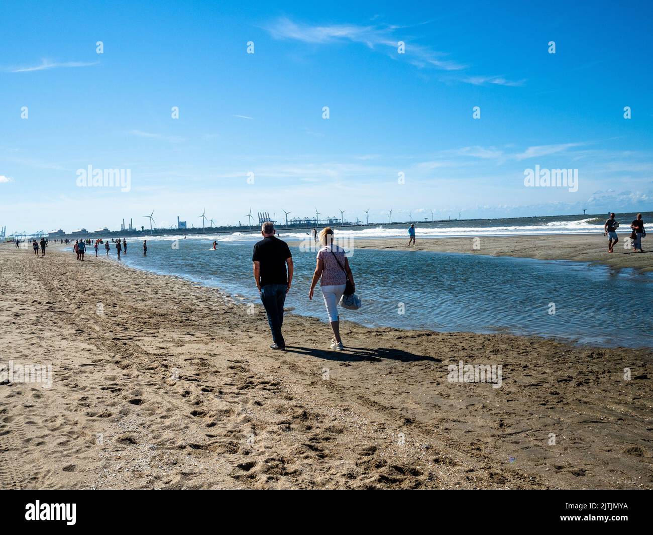 People are seen walking at the edge of the beach. Hoek van Holland’s ...