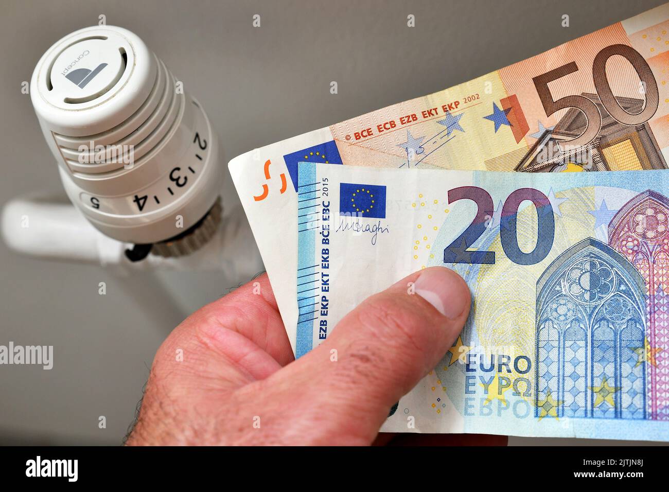Illustration photo - a thermostat on a modern heating system in an ...