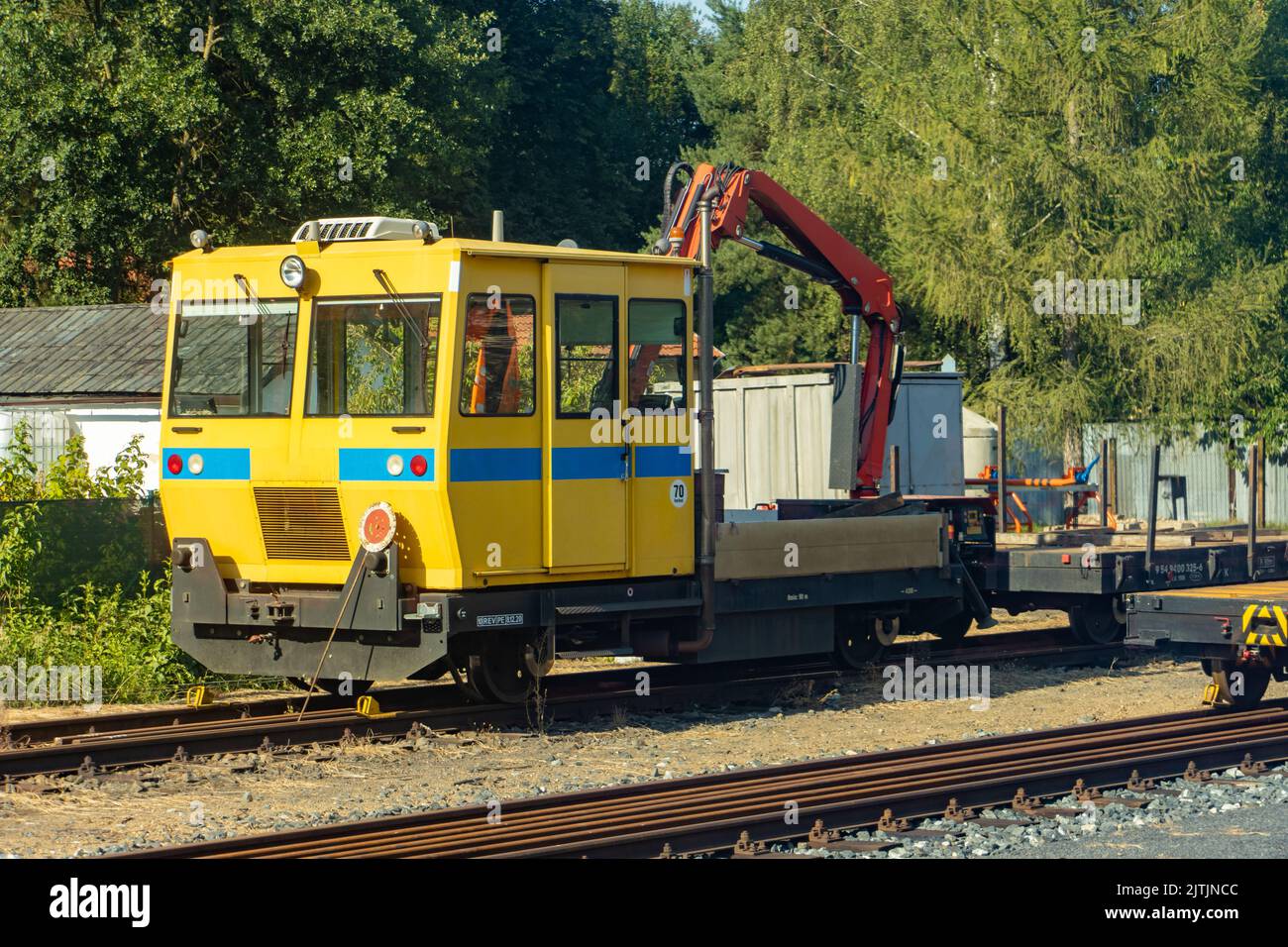 The service rail vehicle with crane on a railways station Stock Photo ...