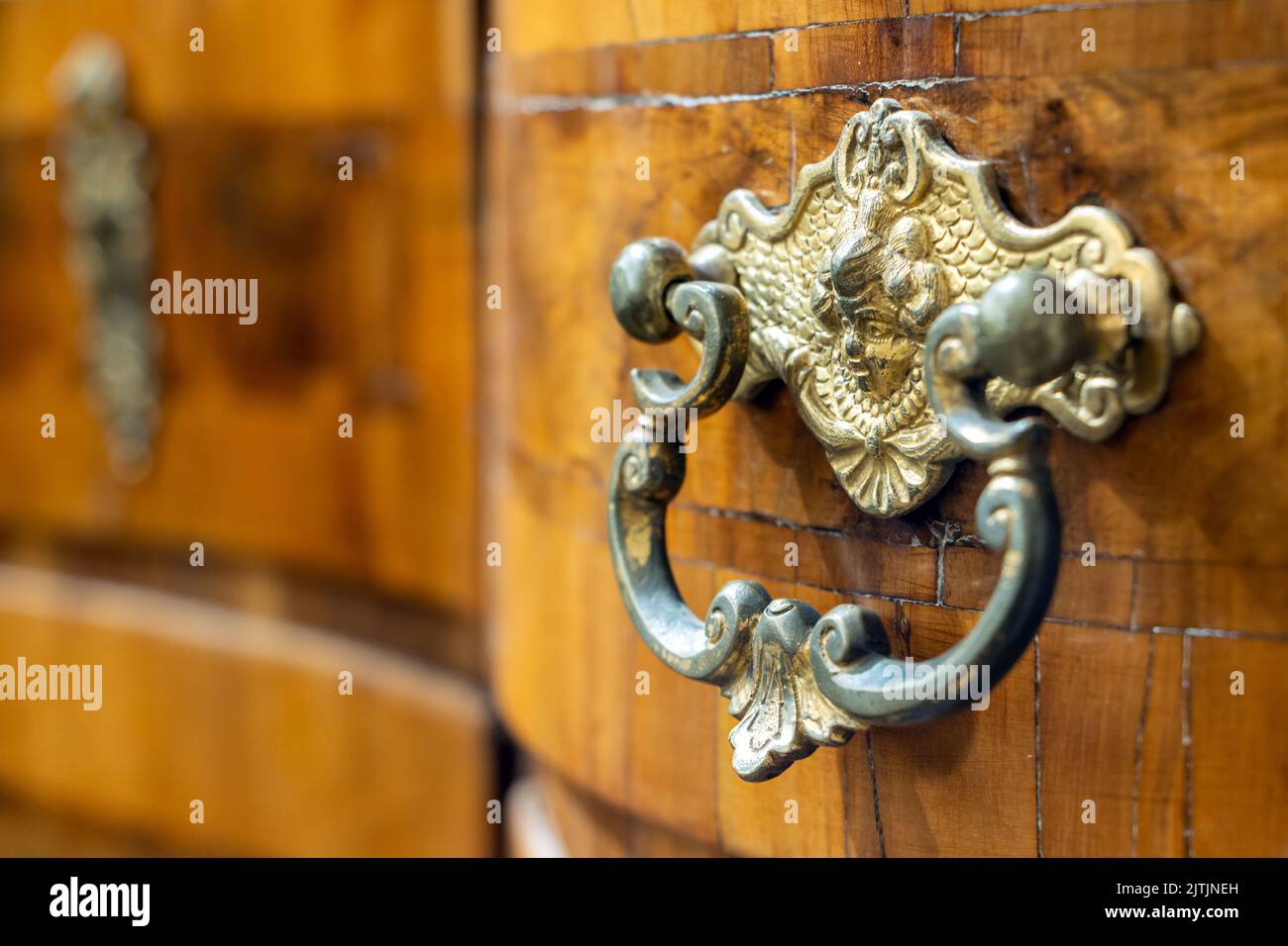 Decorative metal drawer handle in an antique desk with inlaid wood, Mid ...