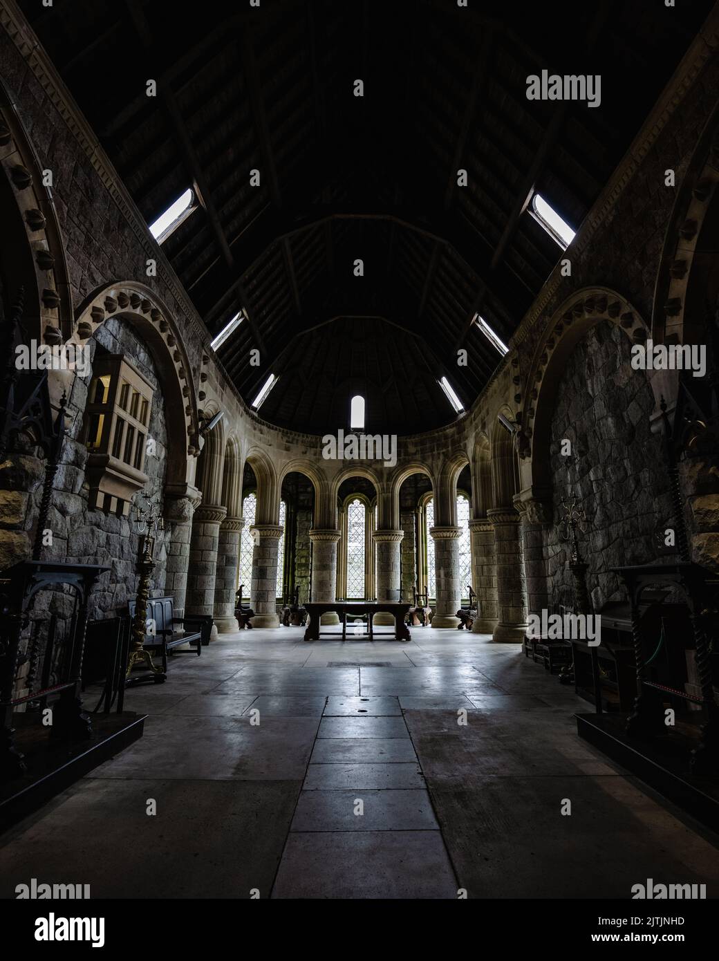 The interior of an ancient stone cathedral with pillars, arches, and ...