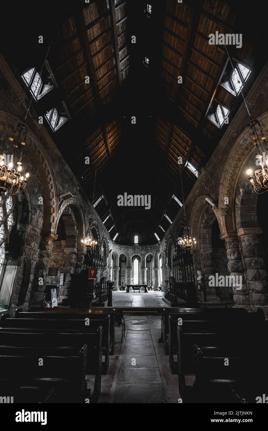 The interior of an ancient stone cathedral with pillars, arches, and ...