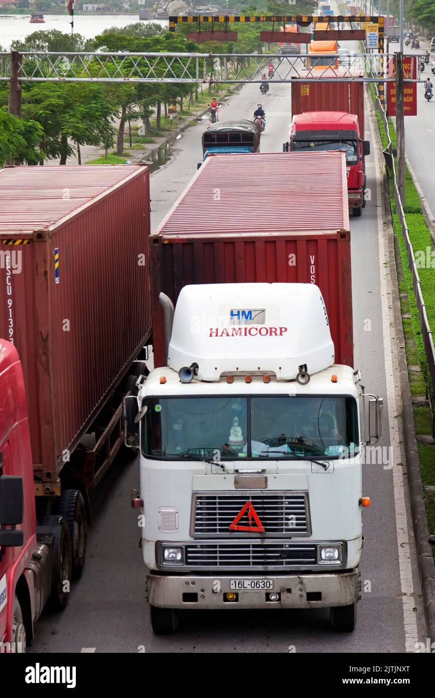 Commercial vehicles in traffic leaving Hai Phong port area, Vietnam ...
