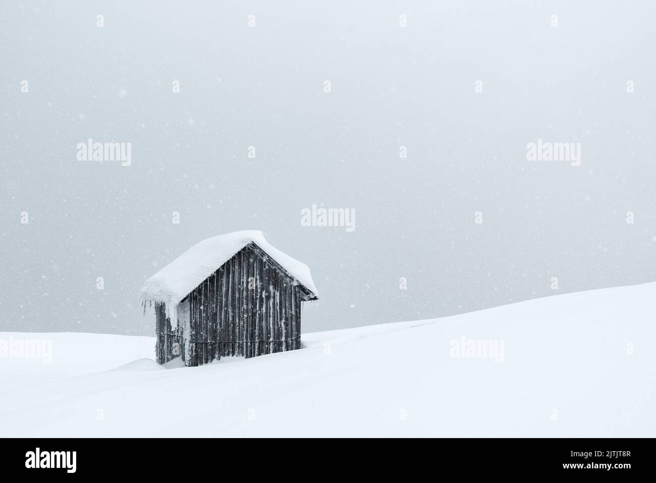 Winter background with a lonely wooden hut in the snow Stock Photo - Alamy