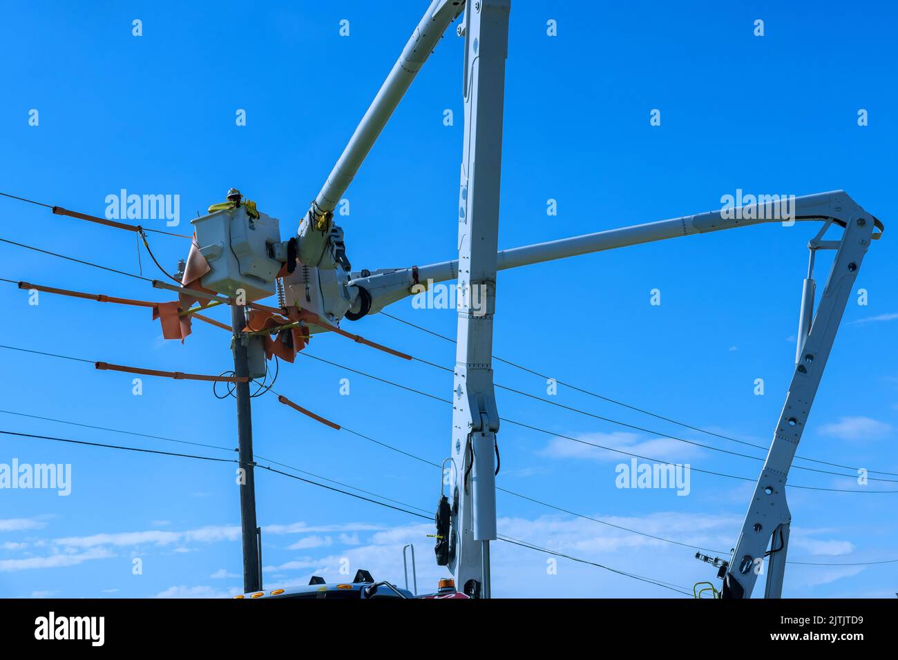 As a result of the storm, electrical workers in the power pole ...