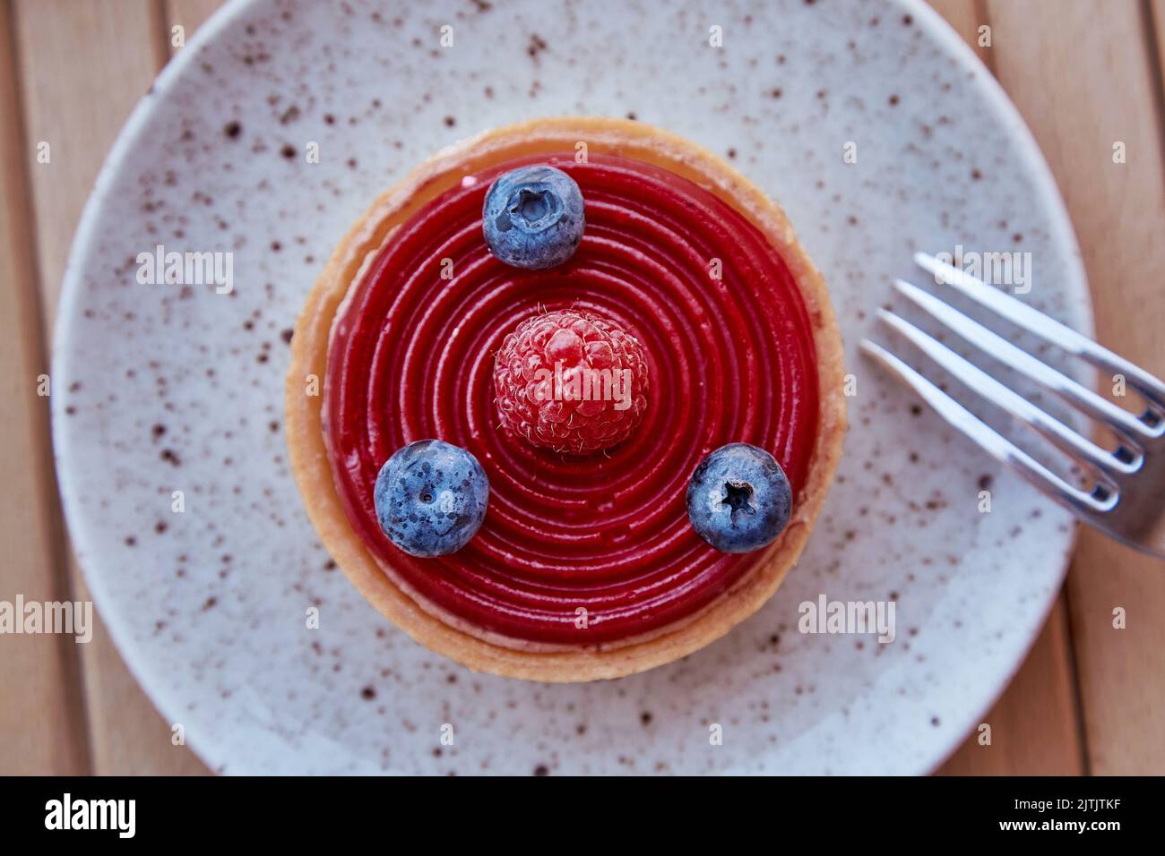 Blueberry and raspberry berry fresh tart on white ceramic plate ...