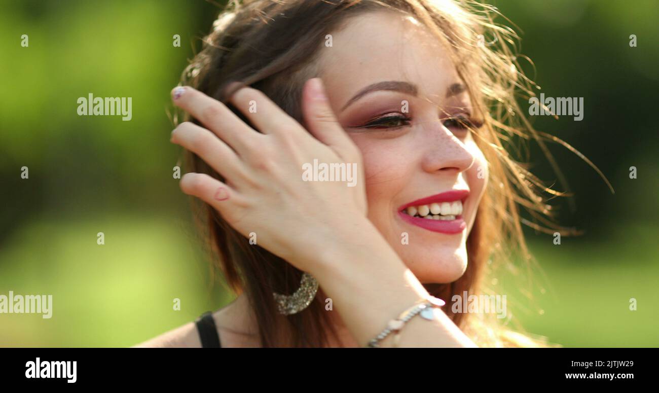 Woman spontaneous smile and laugh in outdoors. Authentic real life girl ...