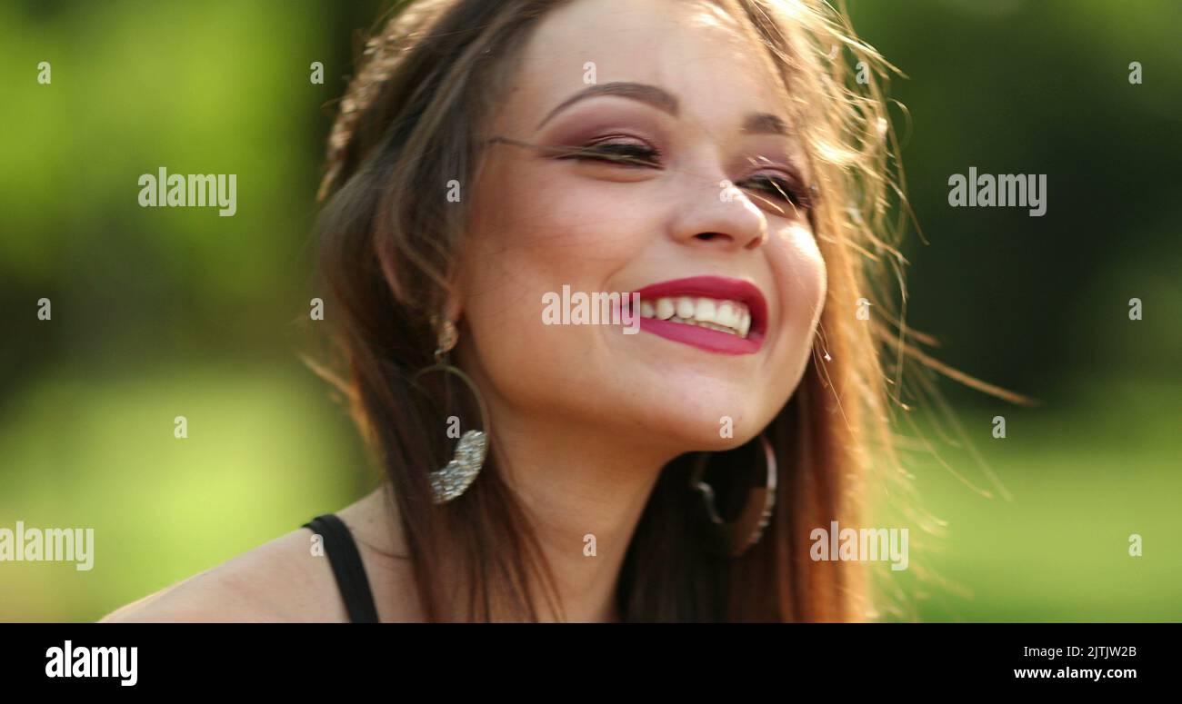 Woman spontaneous smile and laugh in outdoors. Authentic real life girl ...