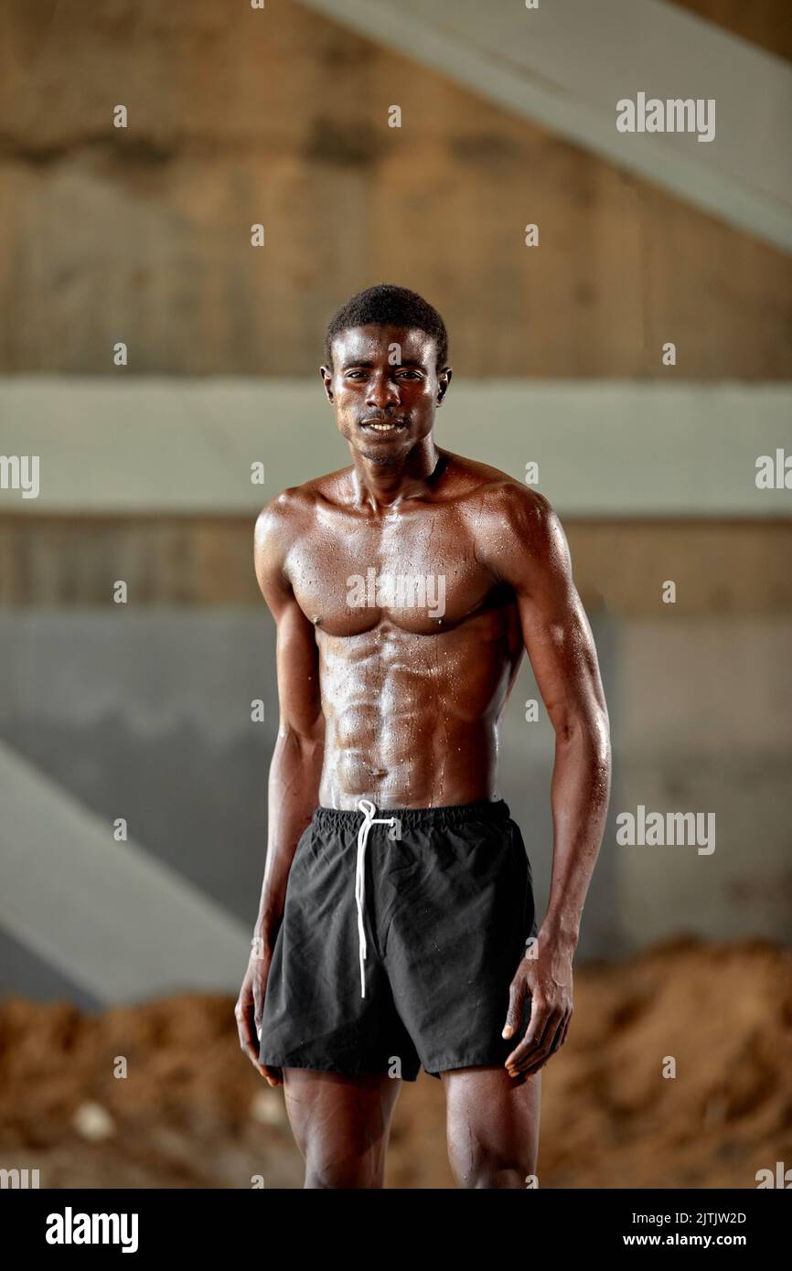 Handsome African American sportman standing on the street while taking ...