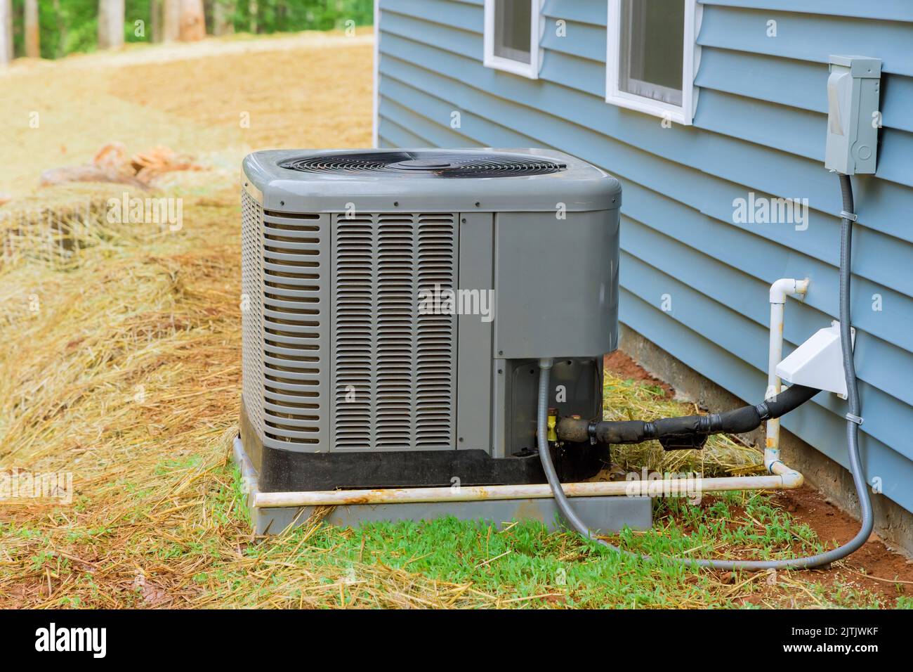 Installation of air conditioner near a new house Stock Photo - Alamy