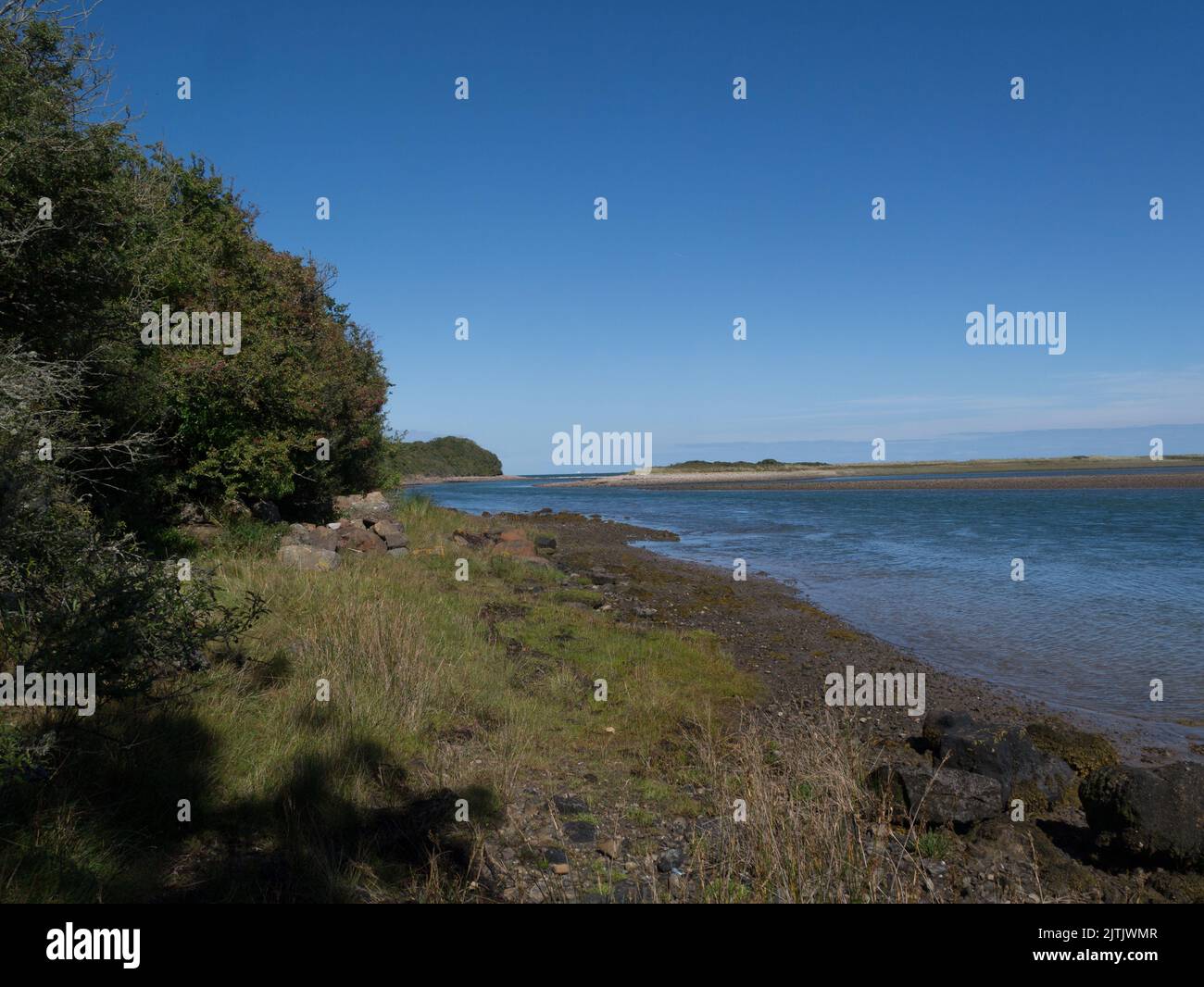 View along Traeth Dulas estuary at high tide towards entrance to Dulas ...
