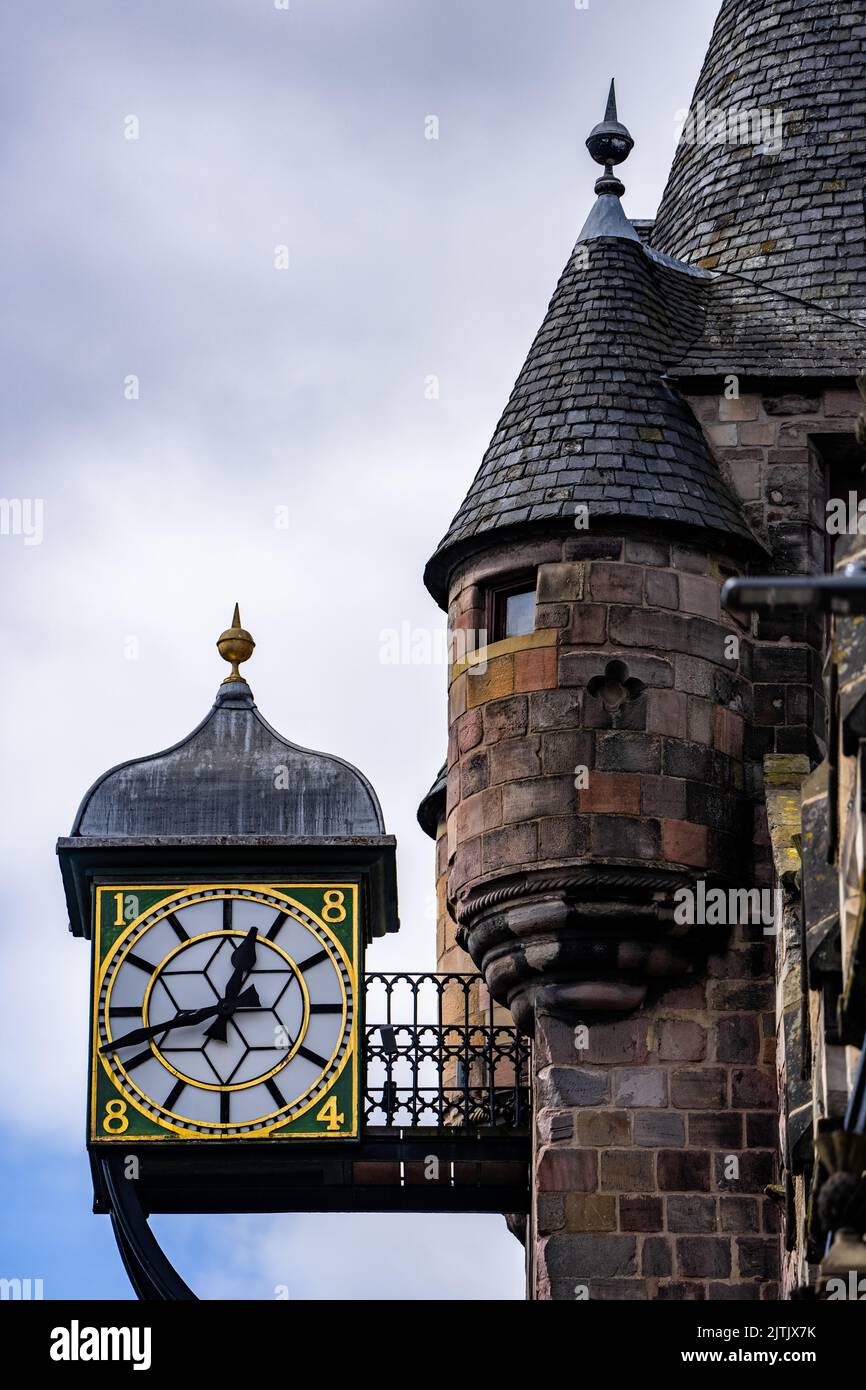 A clock on old stone architecture on the Royal Mile in Edinburgh ...