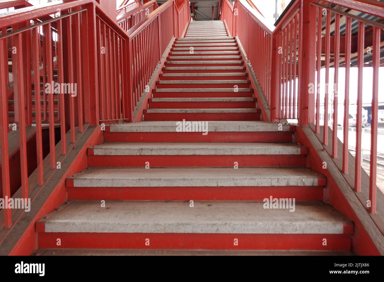 Red stairs leading up to an overpass Stock Photo - Alamy