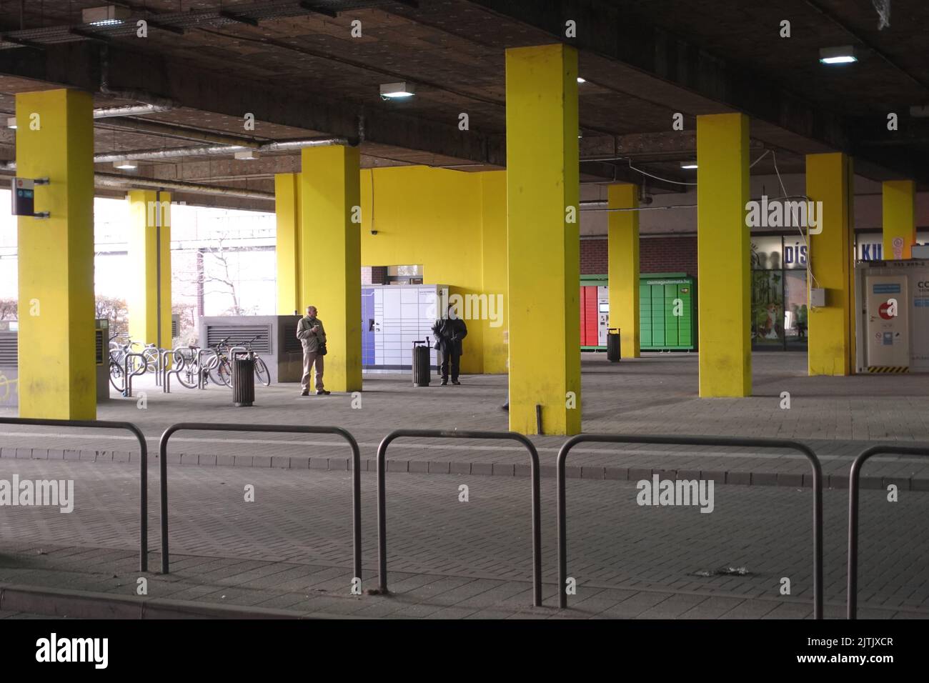 Yellow columns in a spacious underpass area Stock Photo - Alamy