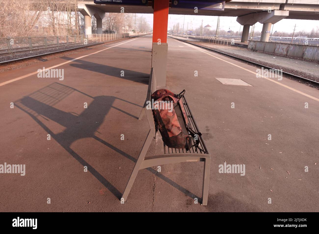 Unattended military pattern backpack on a bench Stock Photo - Alamy