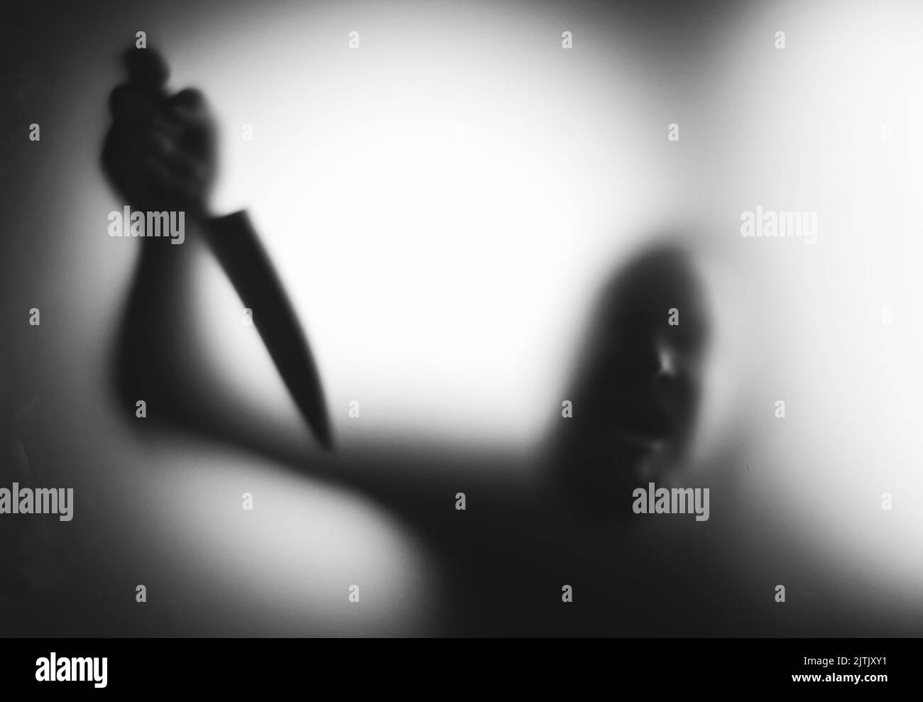 Horror, halloween background - Shadowy figure behind glass holding a ...