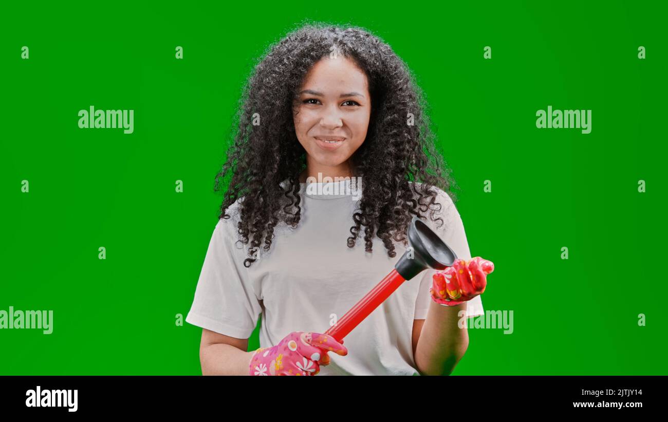An afro female advertising plunger for toilet cleaning on a green ...
