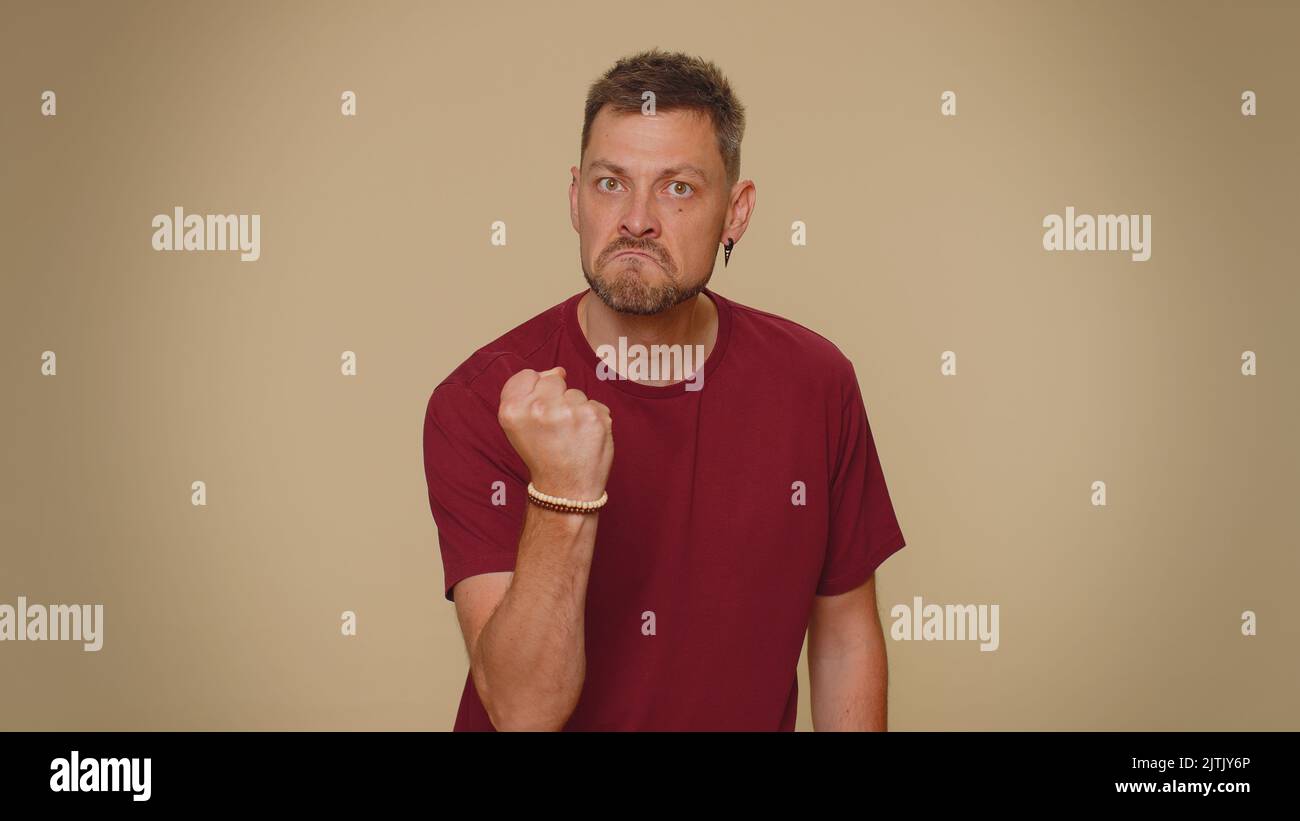 Aggressive angry handsome young man in red t-shirt trying to fight at ...