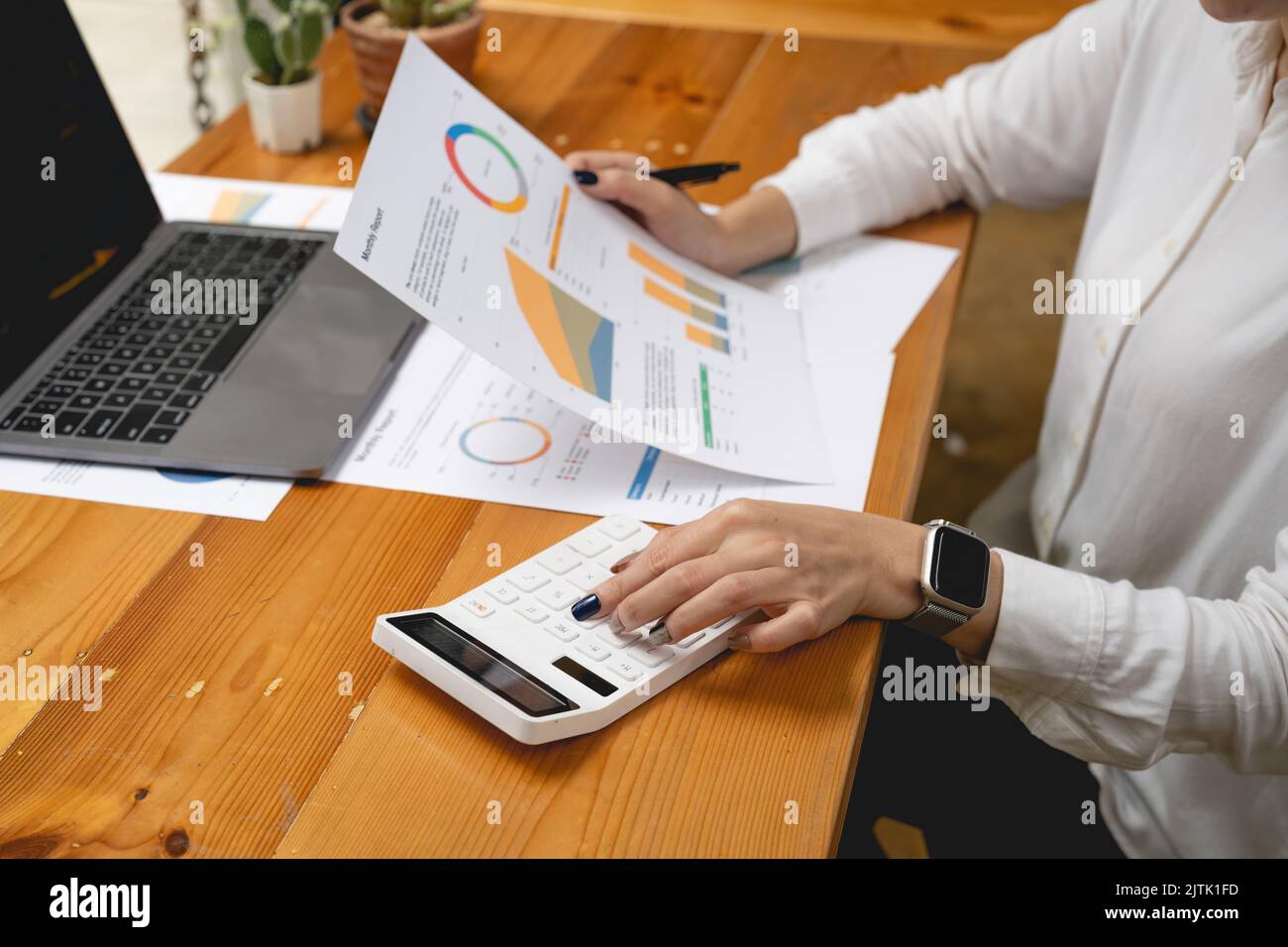 accountant working on desk using calculator for calculate finance ...
