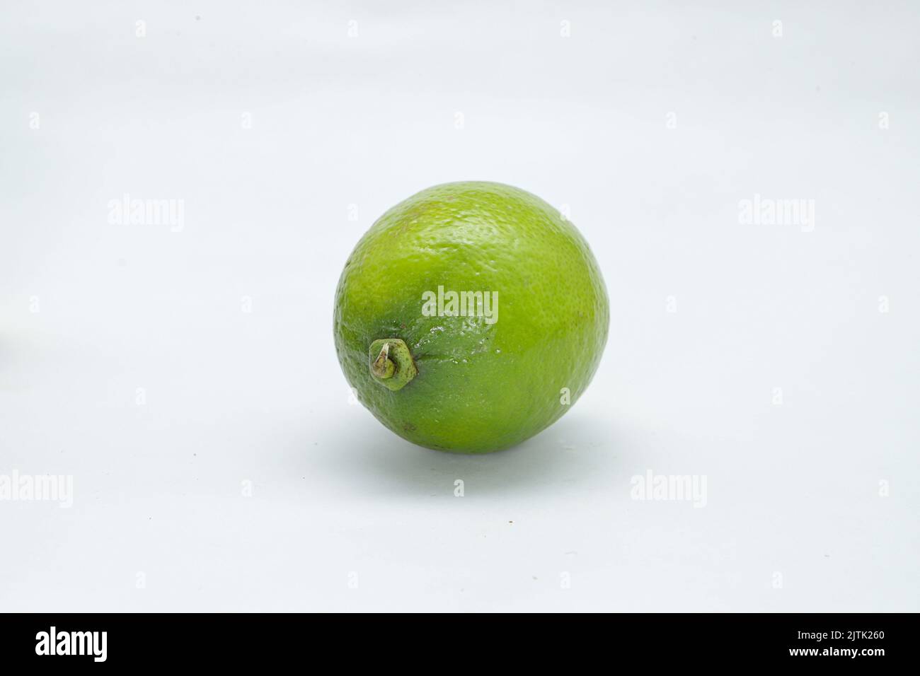 A whole lemon lying on a white background, even lying down, you can see ...