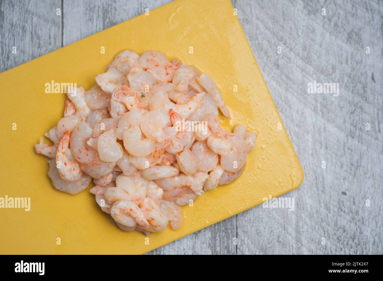 raw king prawn on a chopping board on table Stock Photo - Alamy
