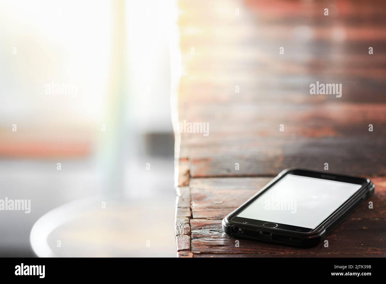 Phone on wood table, White screen on phone Stock Photo - Alamy