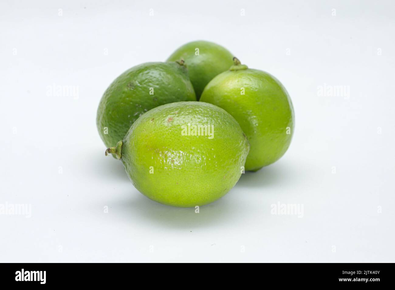 Four lemons on a white background, placing one in front, this one with ...
