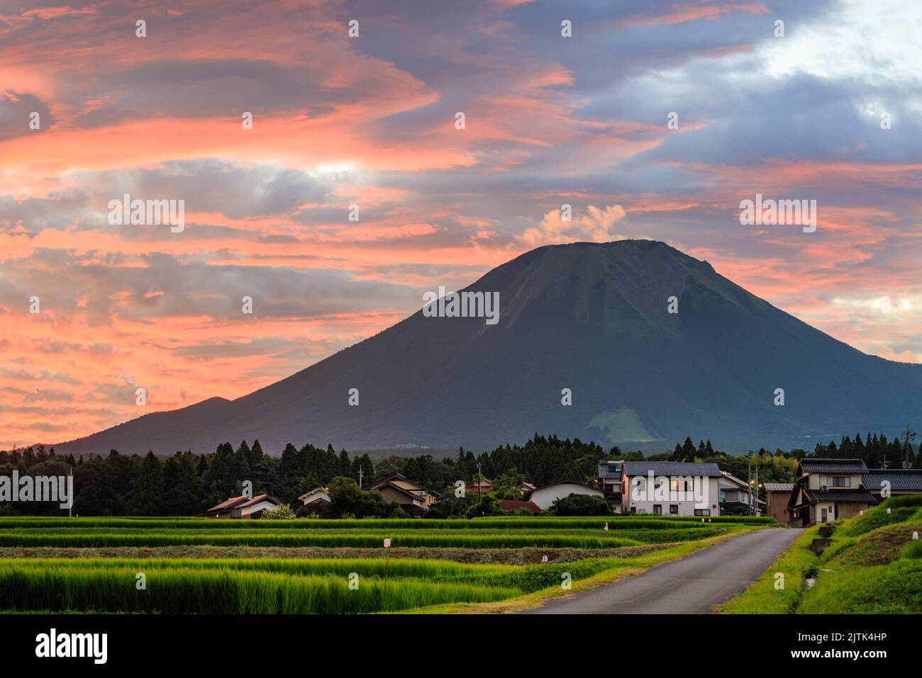 Early morning light hits mist at peak of Mt. Daisen under sunrise sky ...