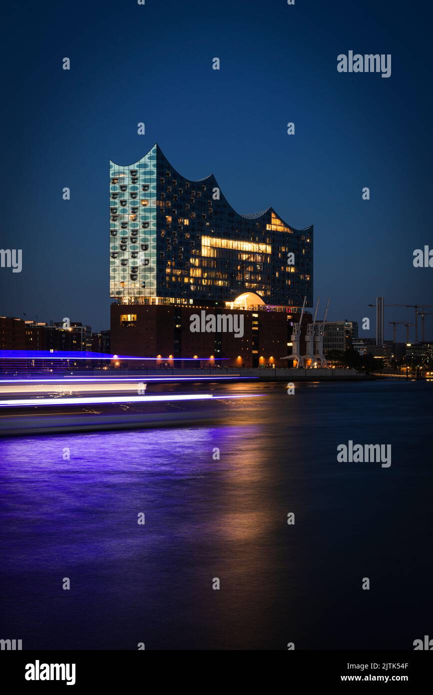 The Elbe Philharmonic Hall in Hamburg harbour glows in the blue hour of ...