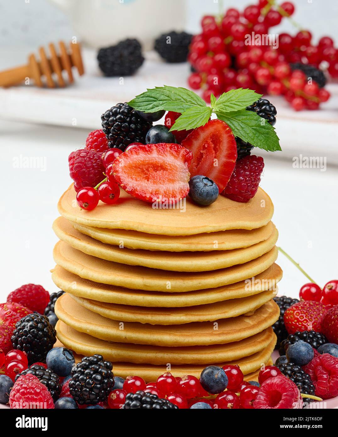 Stack of pancakes with fresh fruits poured with syrup Stock Photo - Alamy
