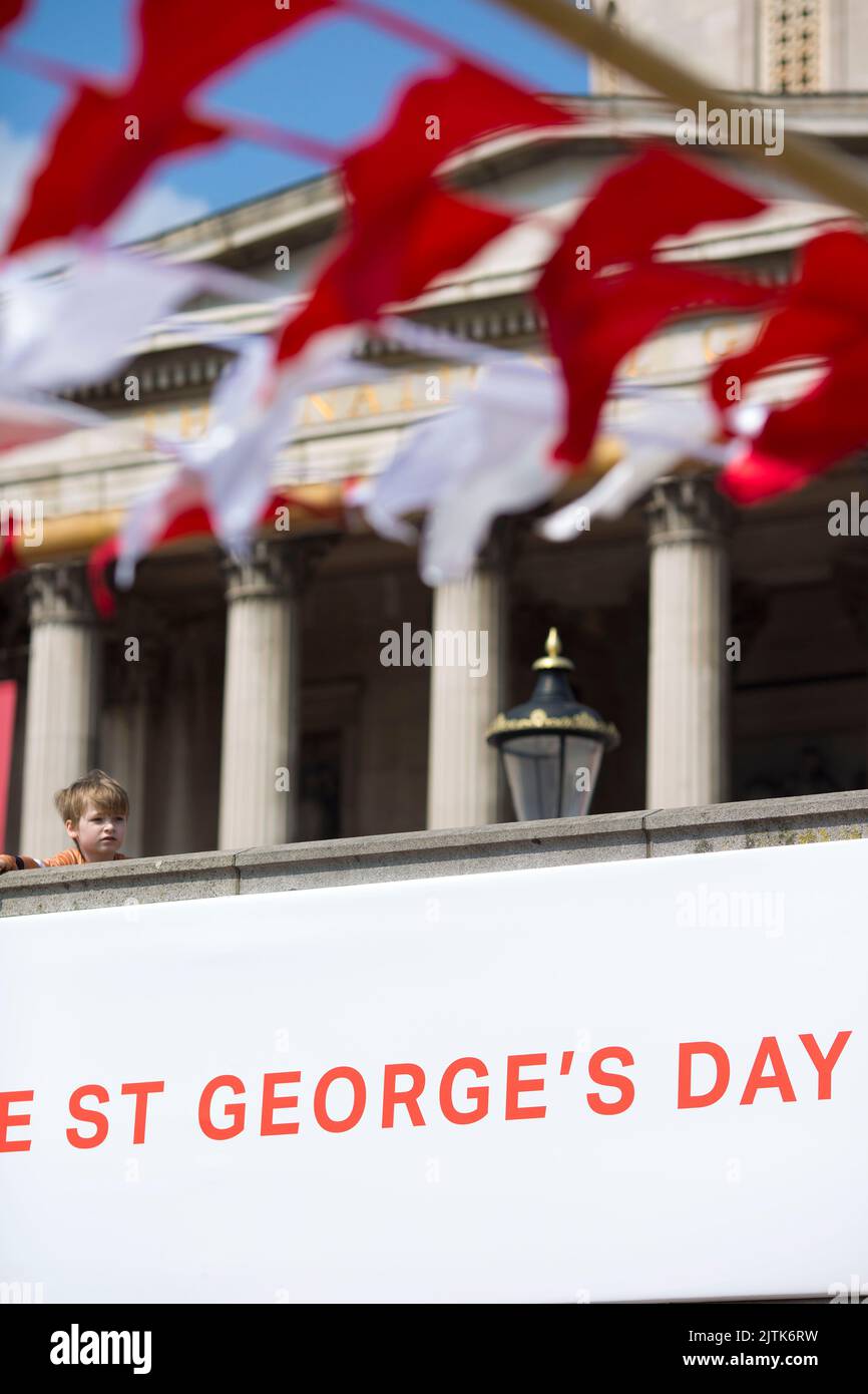 A spectator is seen behind decorations as people gather for St George’s ...