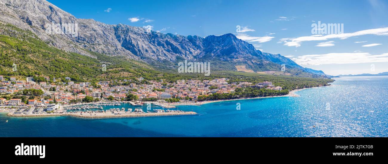 Panorama of Baska Voda town with harbor against mountains in Makarska ...