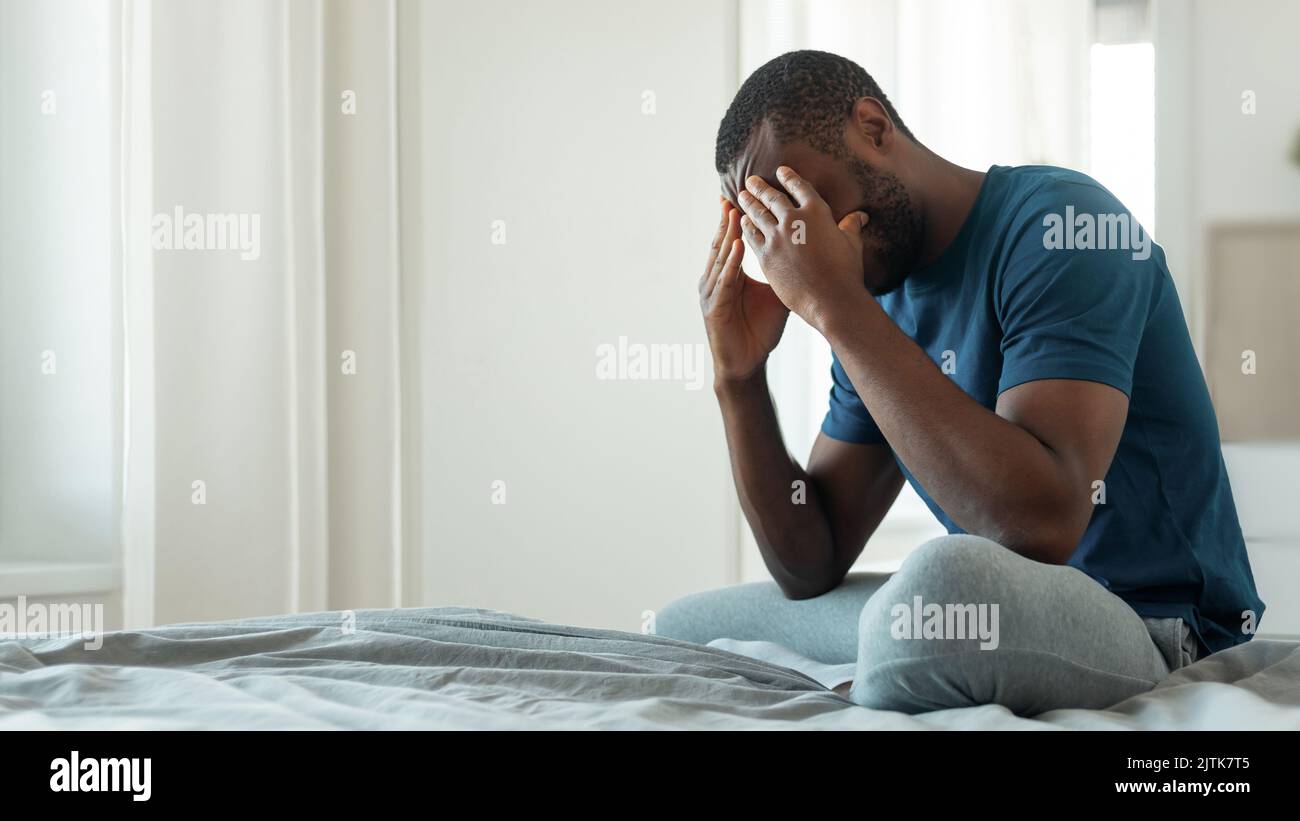 Young african man sitting crying hi-res stock photography and images ...