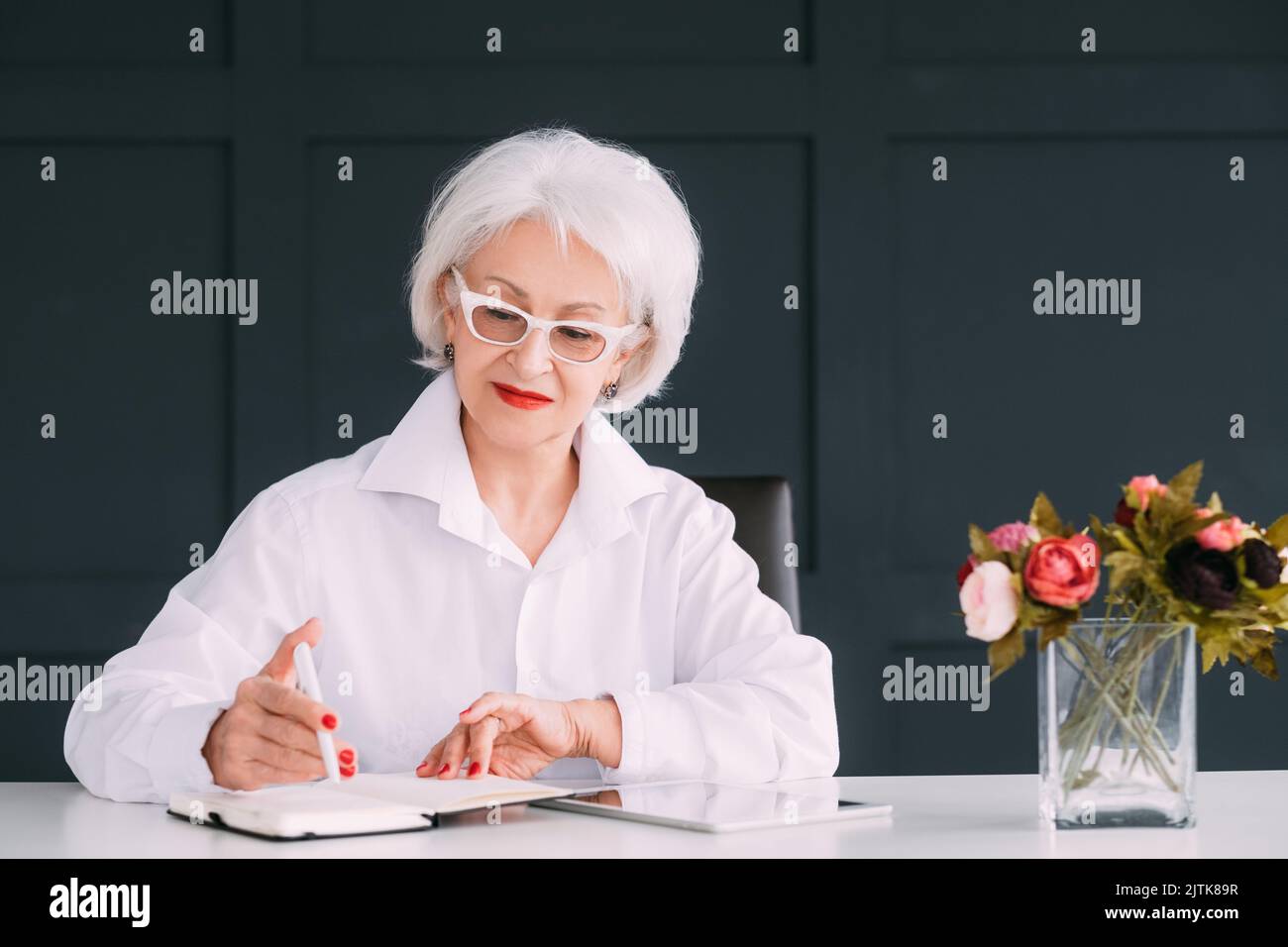 senior business woman portrait day planning notes Stock Photo - Alamy
