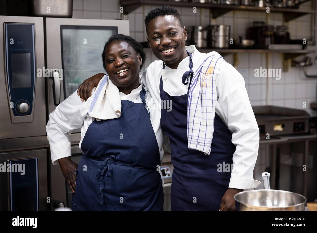 Happy chefs standing together in restaurant kitchen Stock Photo - Alamy