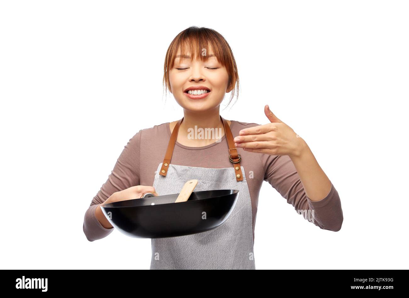 happy female chef with frying pan smelling food Stock Photo - Alamy