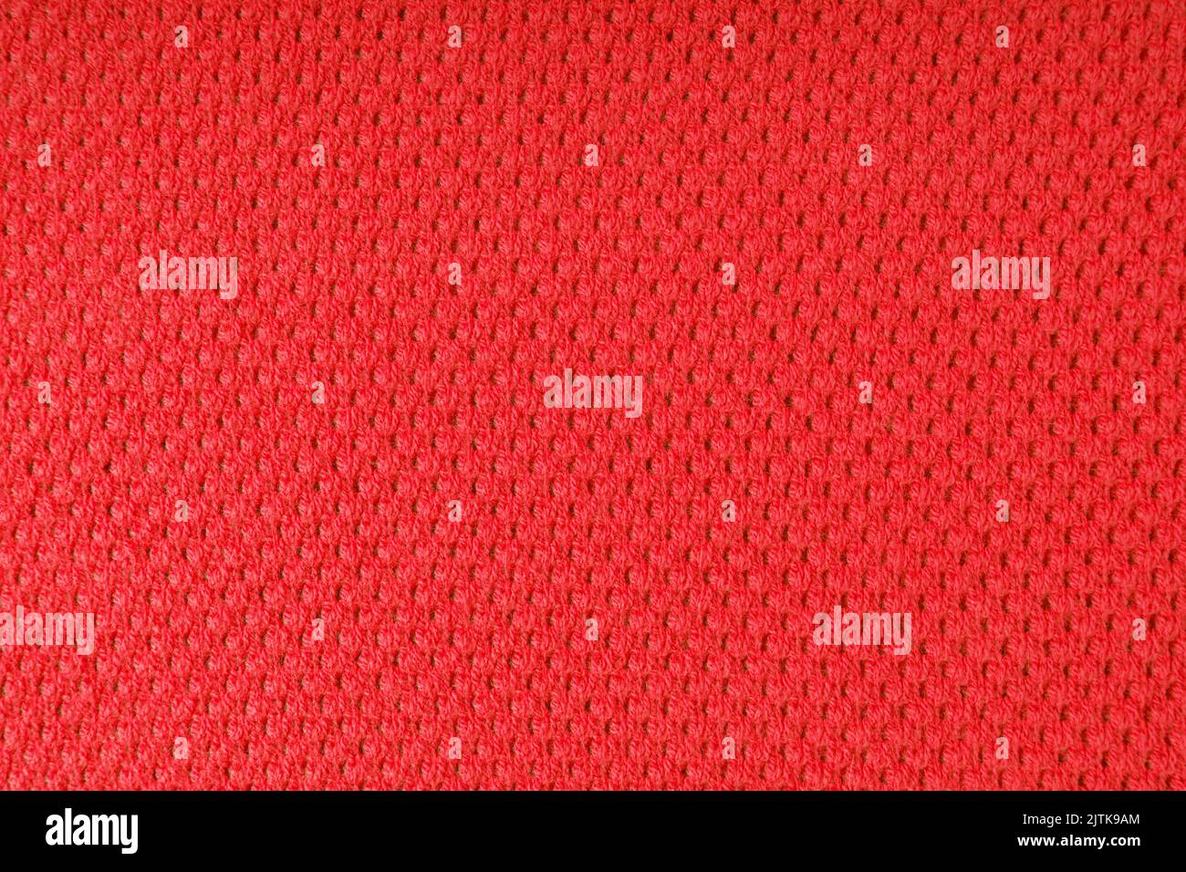Close up background of knitted wool fabric with dots pattern. Bright ...