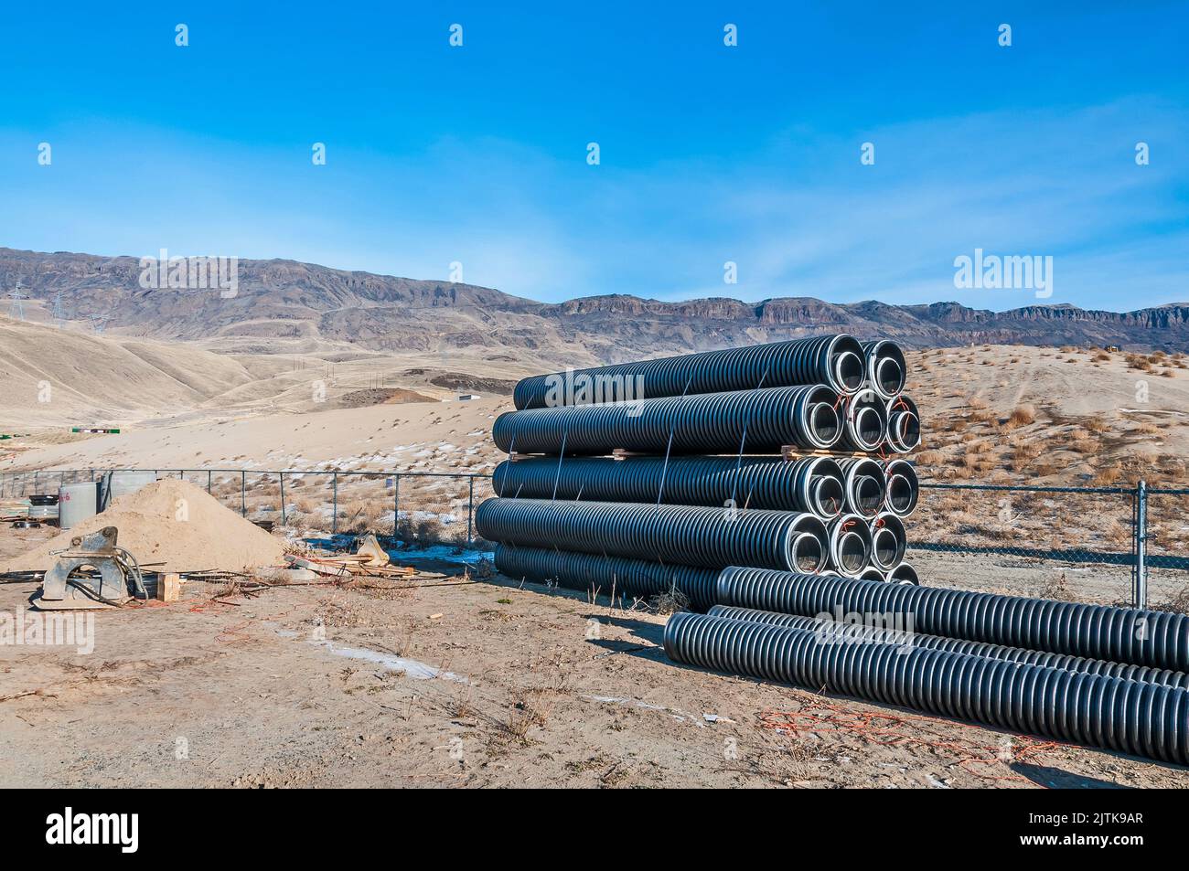 Flexible conduit or culvert pipes stacked up in an active landfill or ...