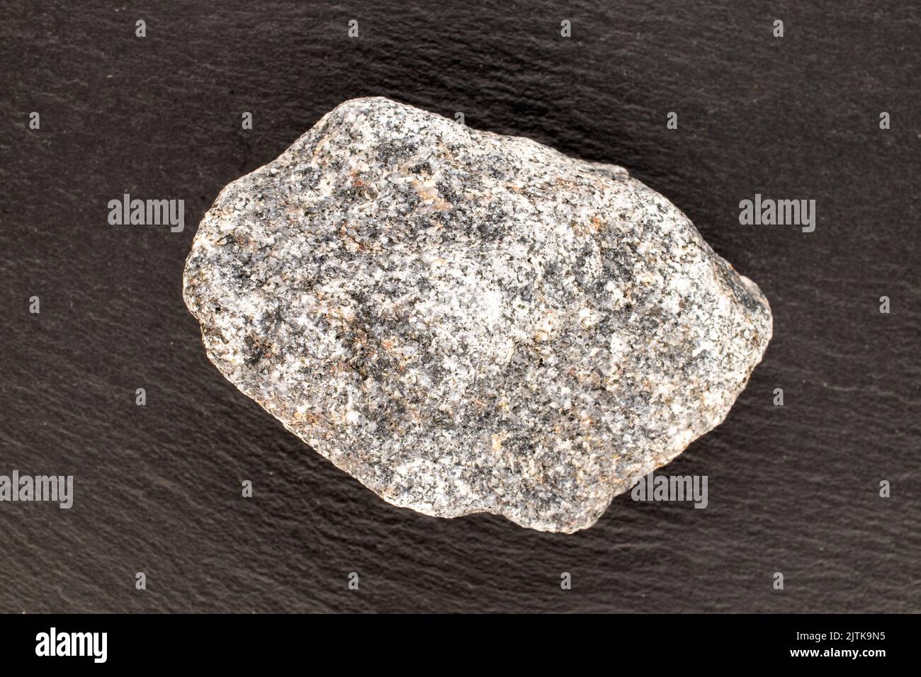 One granite stone on slate, close up, top view Stock Photo - Alamy