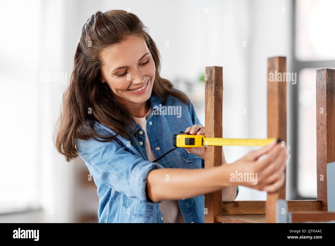 woman with ruler measuring table for renovation Stock Photo - Alamy