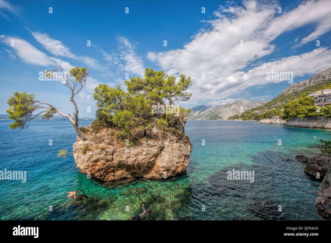 Punta Rata beach with stone island against sunset in Brela, Makarska ...