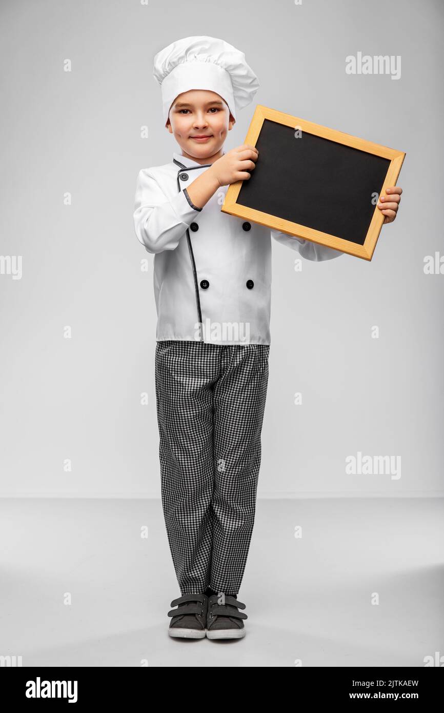 happy little boy in chef's toque with chalkboard Stock Photo - Alamy