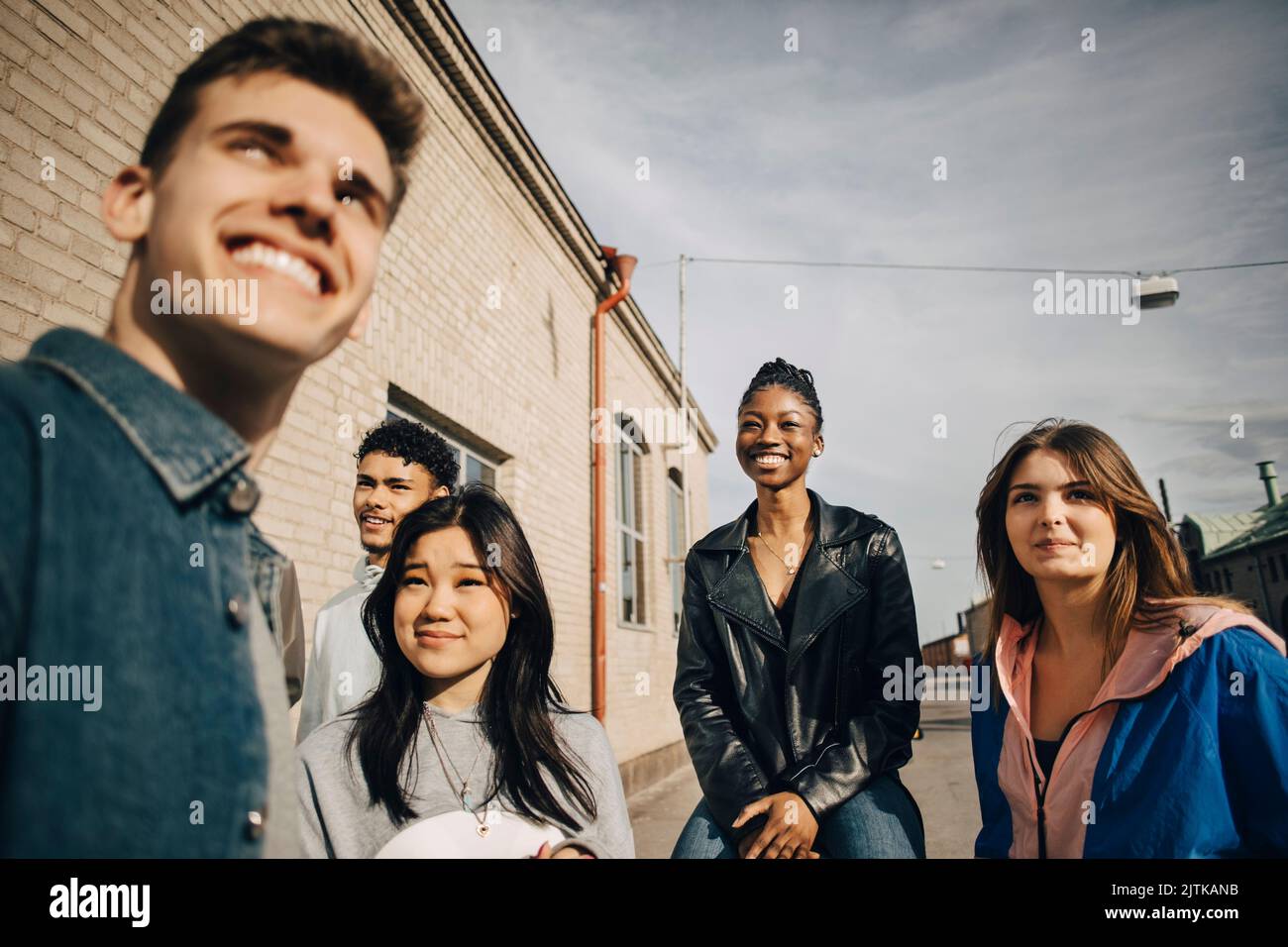 Group young gen friends sitting hi-res stock photography and images - Alamy
