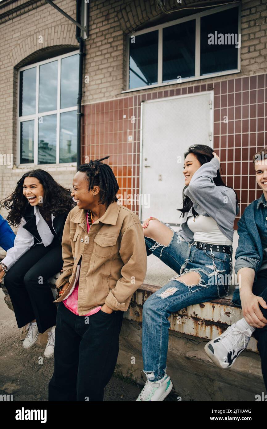 Happy multiracial young friends outside building Stock Photo - Alamy