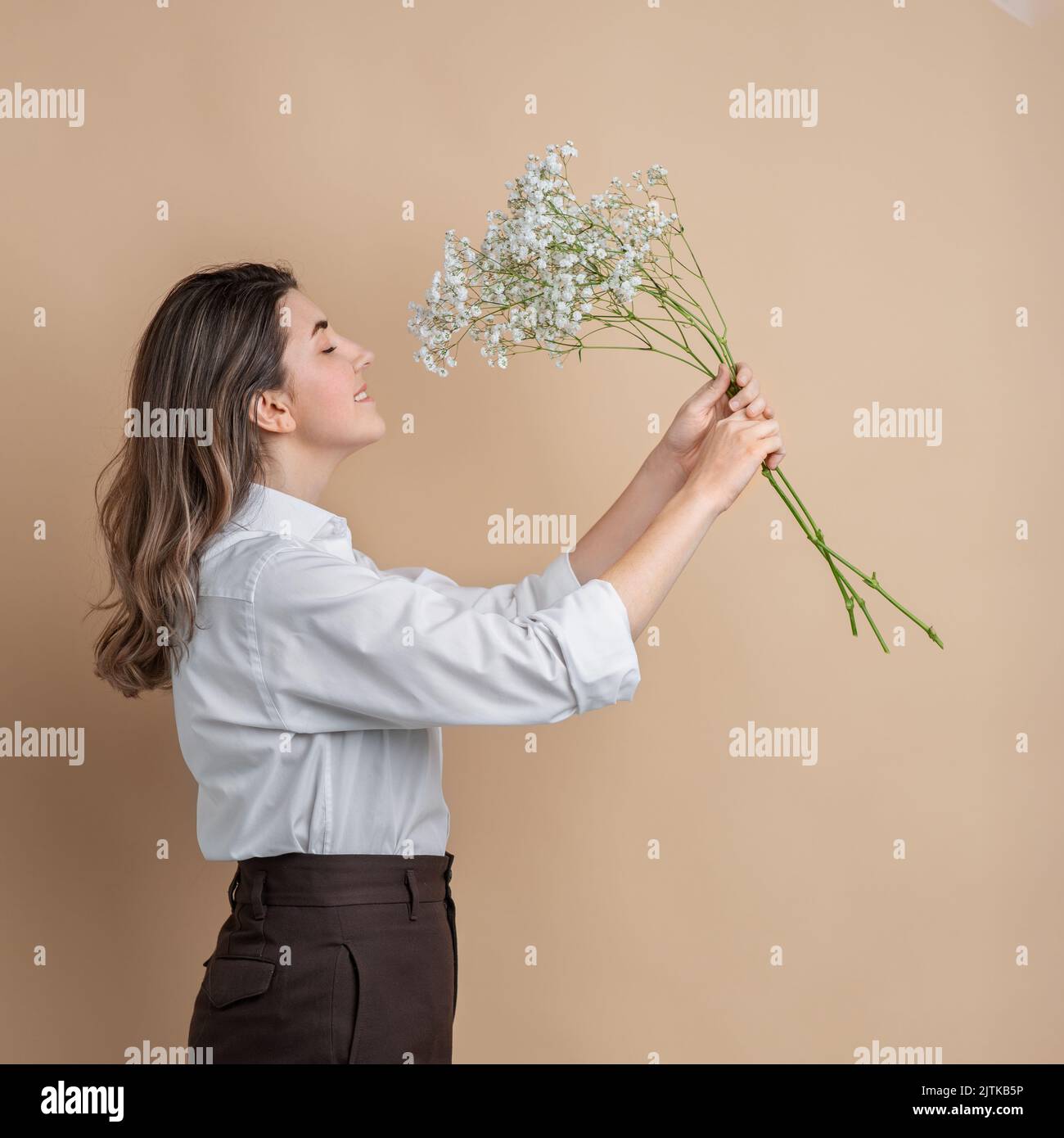 Happy woman smelling flower hi-res stock photography and images - Alamy