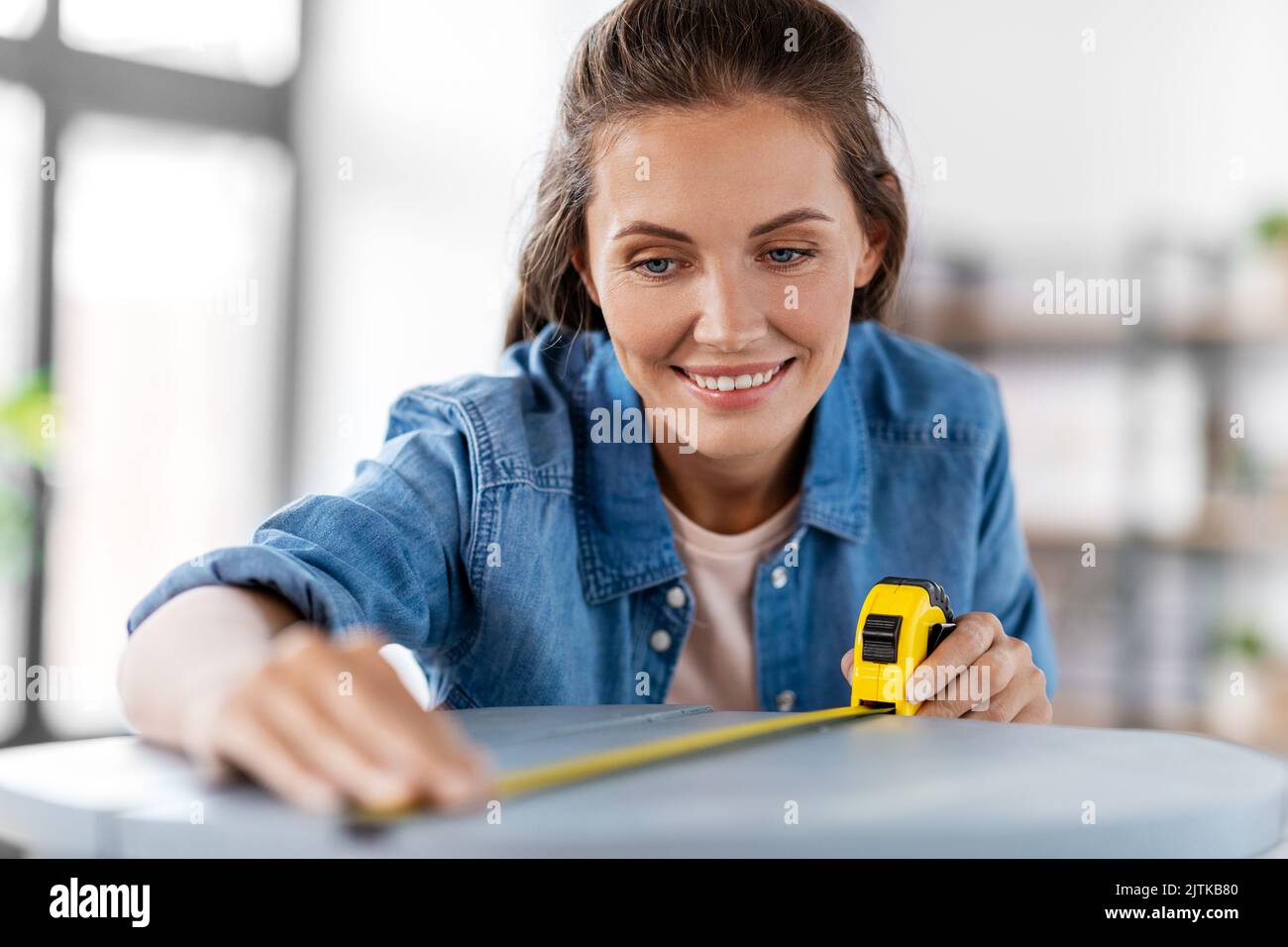 woman with ruler measuring table for renovation Stock Photo - Alamy