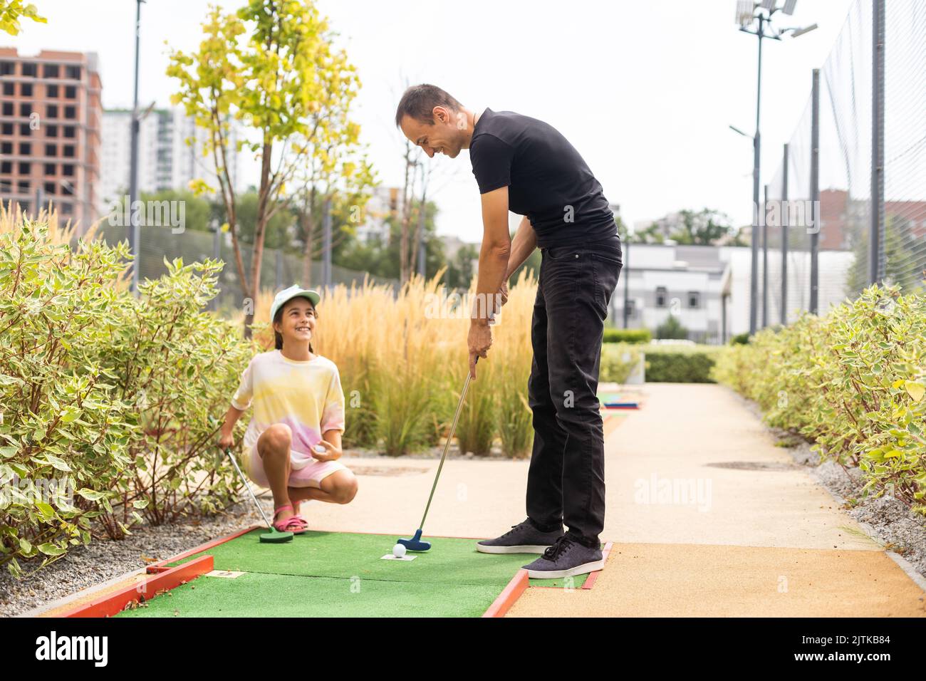 Family: Family Time Playing Mini-Golf In The Summer Stock Photo - Alamy