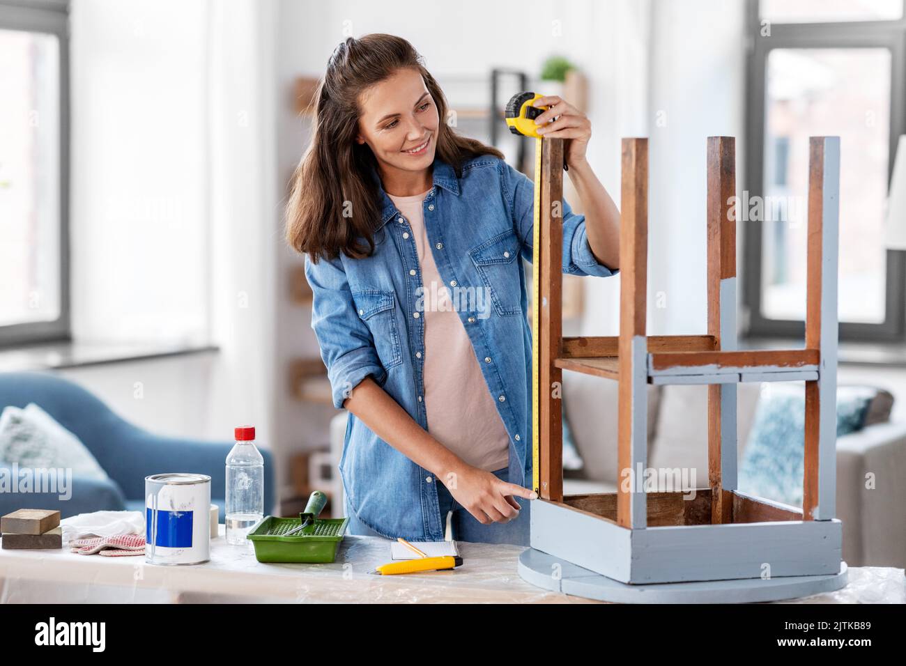 woman with ruler measuring table for renovation Stock Photo - Alamy